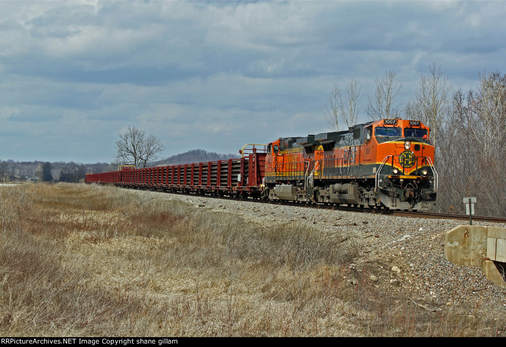 BNSF 1007 Takes a loaded rail train Sb.